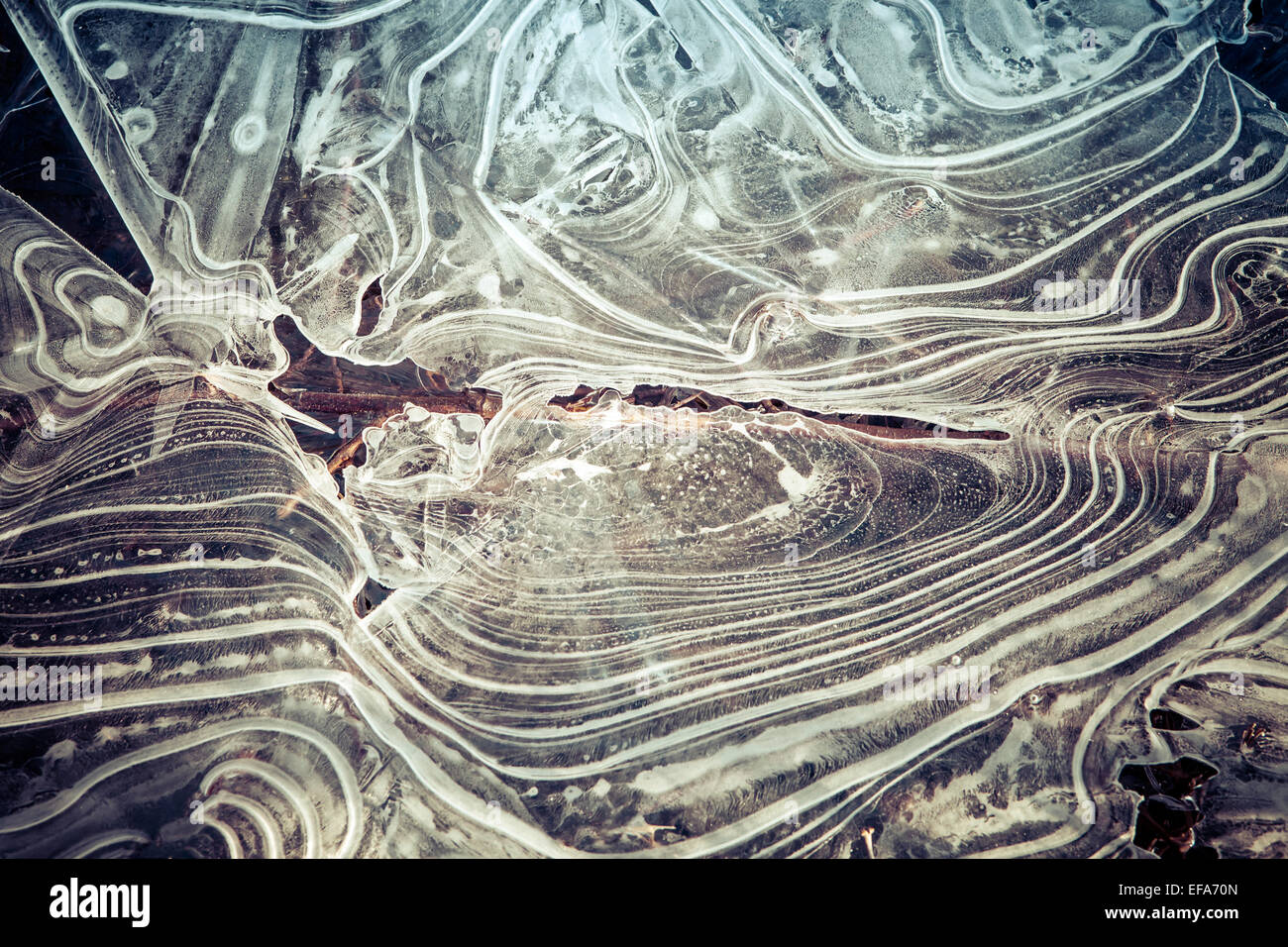 Swirling ice patterns at the edge of a frozen pond Stock Photo - Alamy