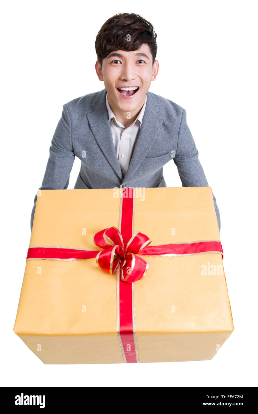 Young man laughing with a large gift Stock Photo - Alamy