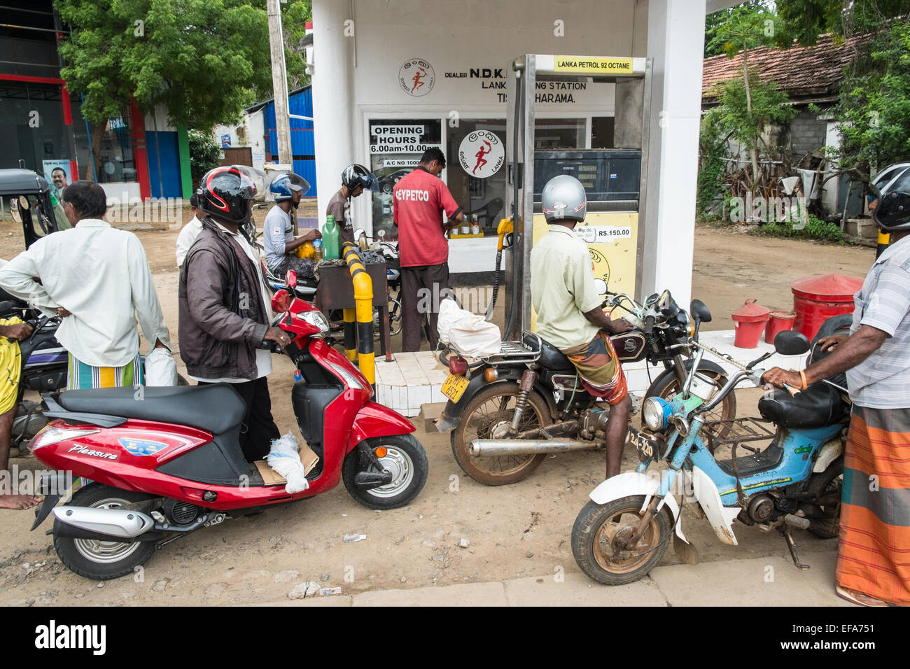 Queueing for petrol to fill the tank of these scooters,motorbikes at ...