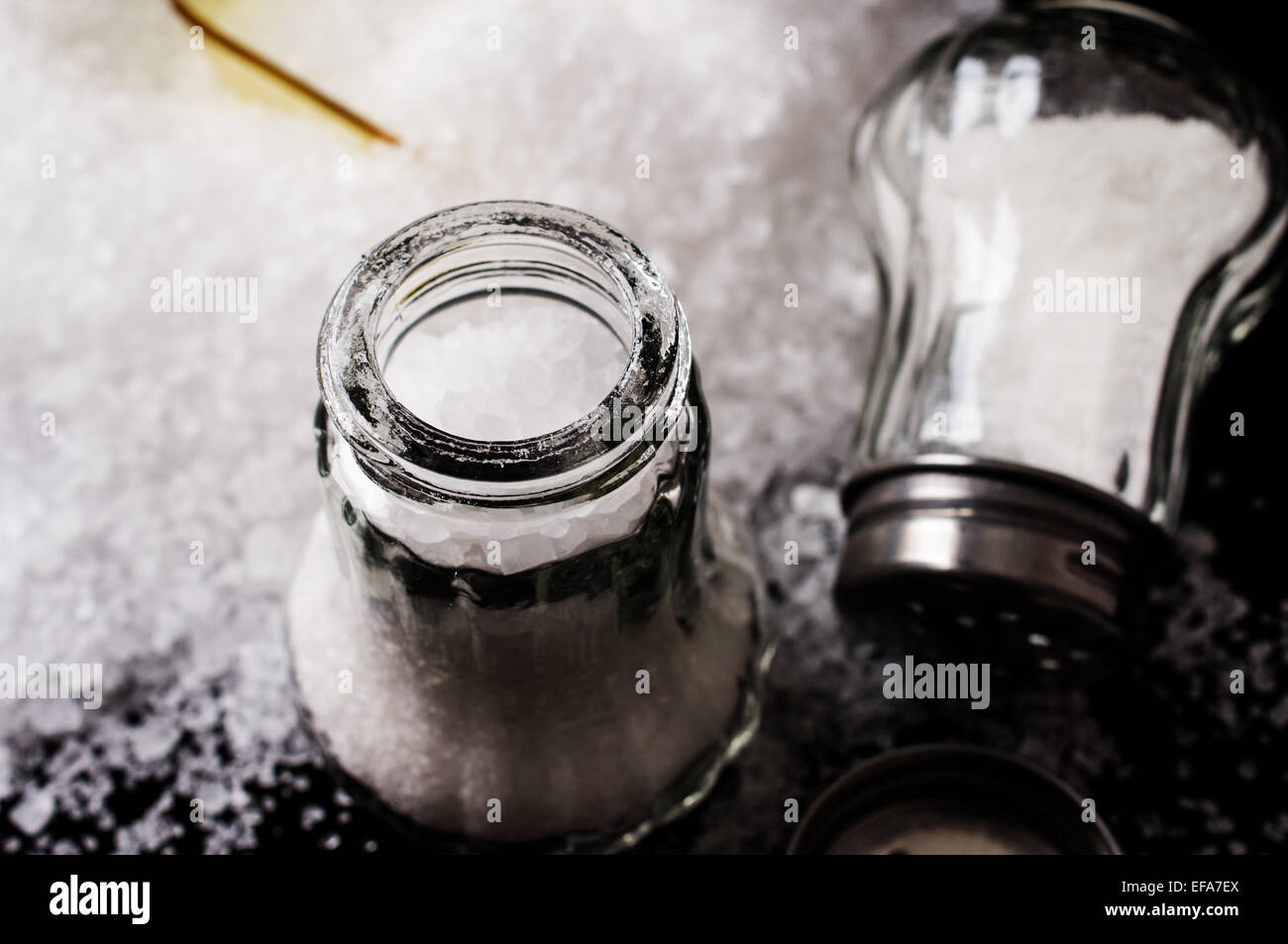 Two glass salt shakers and salt Stock Photo - Alamy