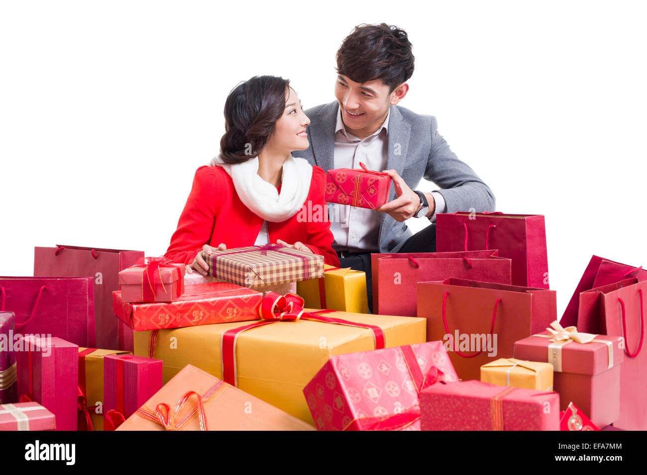 Happy young couple with many gifts Stock Photo - Alamy