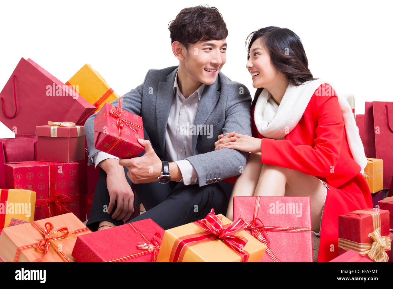 Happy young couple with many gifts Stock Photo - Alamy