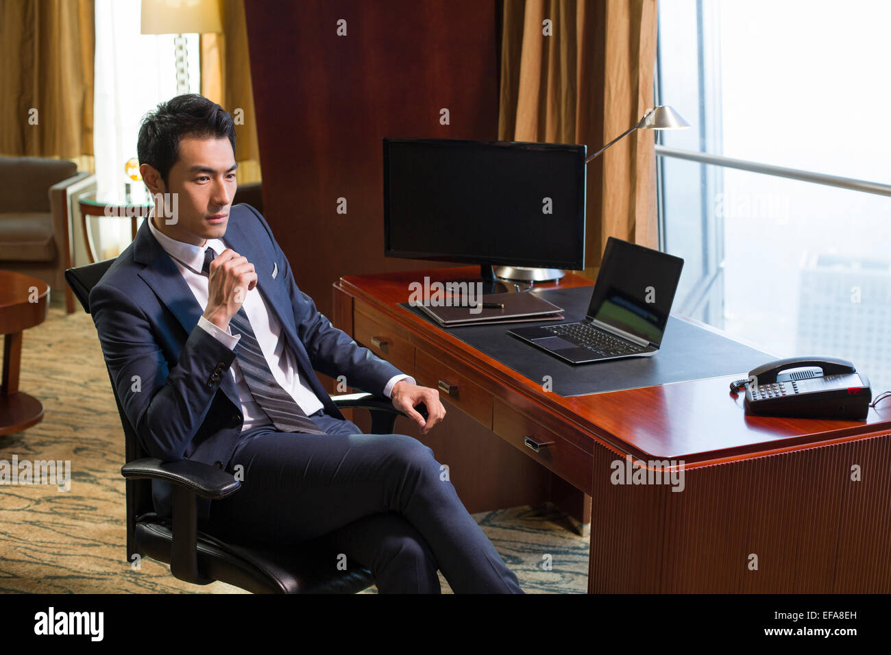 Successful businessman thinking in study Stock Photo - Alamy