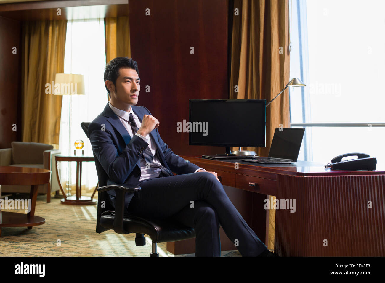 Successful businessman thinking in study Stock Photo - Alamy