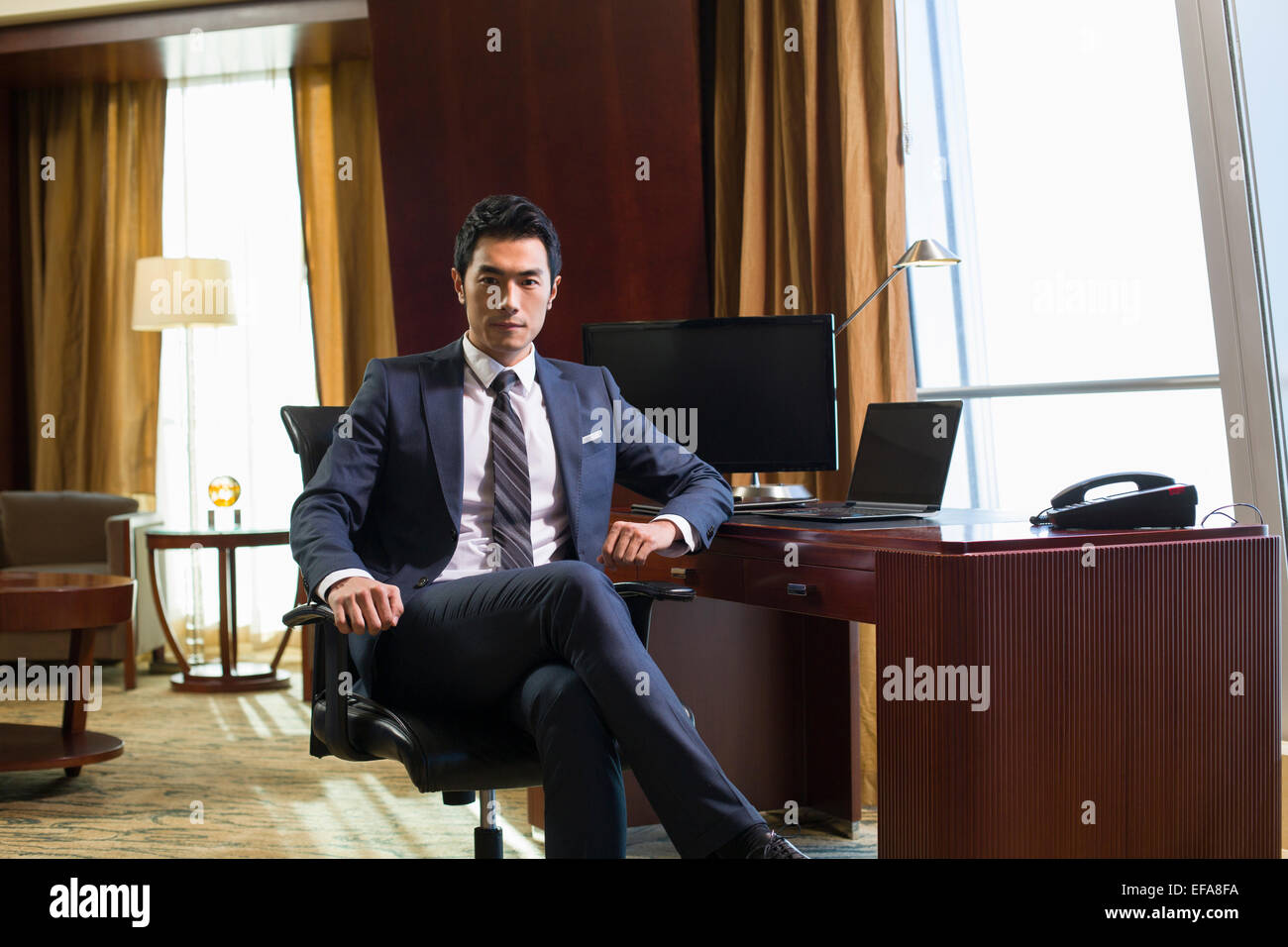 Portrait of successful businessman in study Stock Photo - Alamy