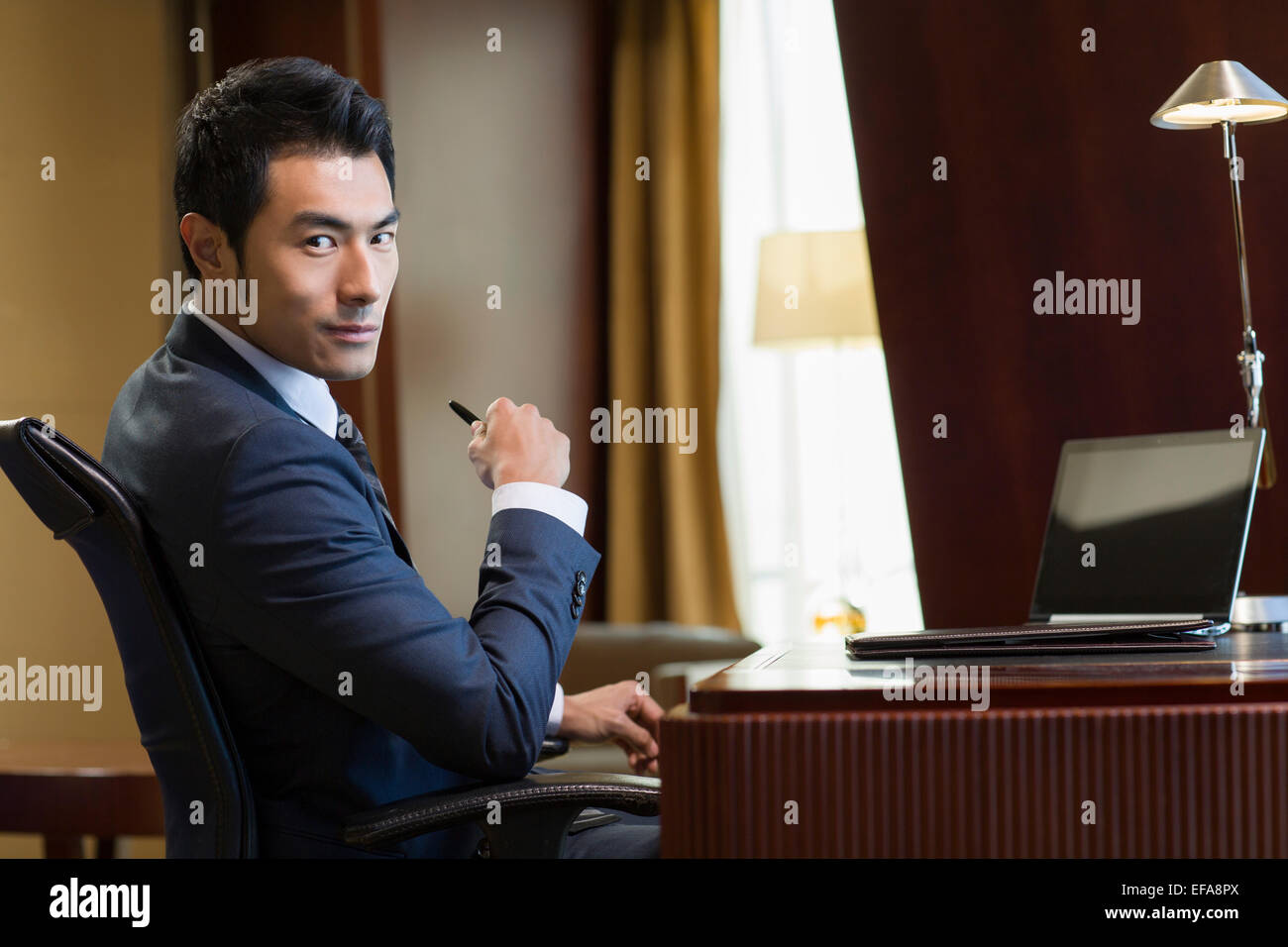 Portrait of successful businessman in study Stock Photo - Alamy