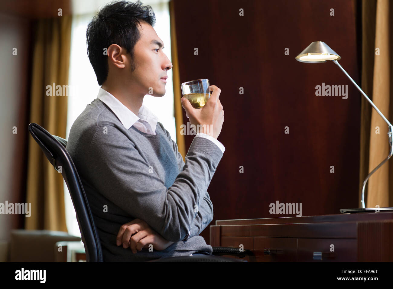 Young businessman thinking in study Stock Photo - Alamy