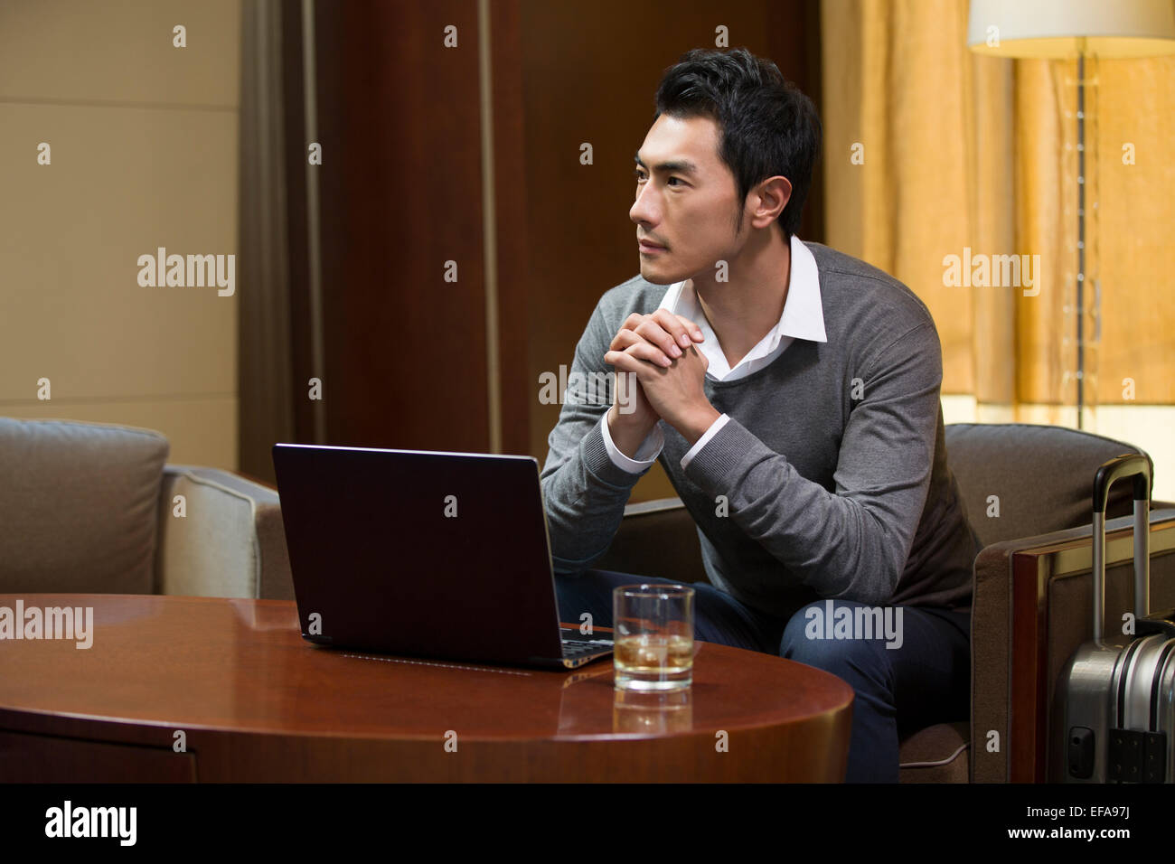 Young businessman thinking in hotel room Stock Photo - Alamy