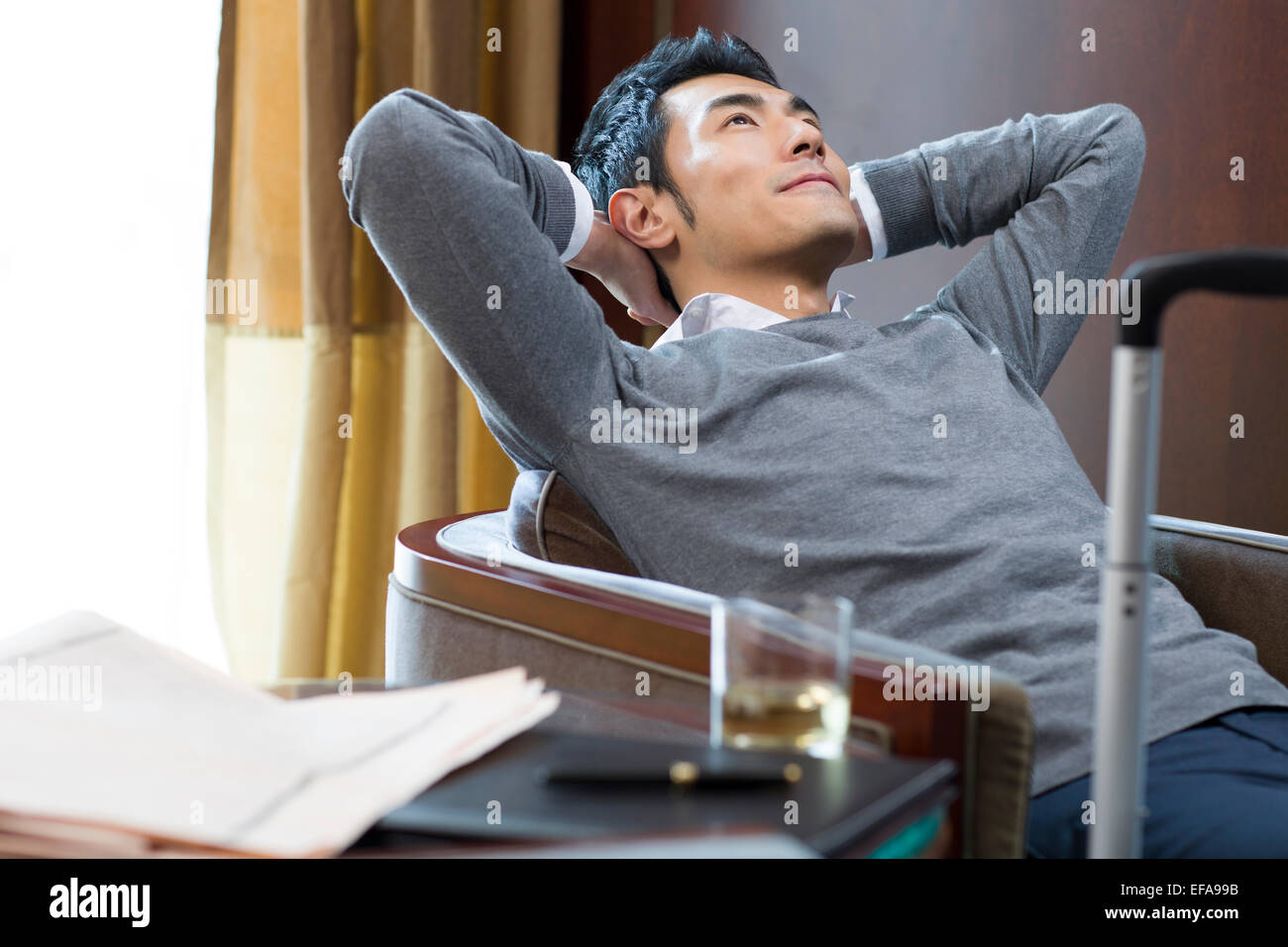 Young businessman resting in hotel room Stock Photo - Alamy