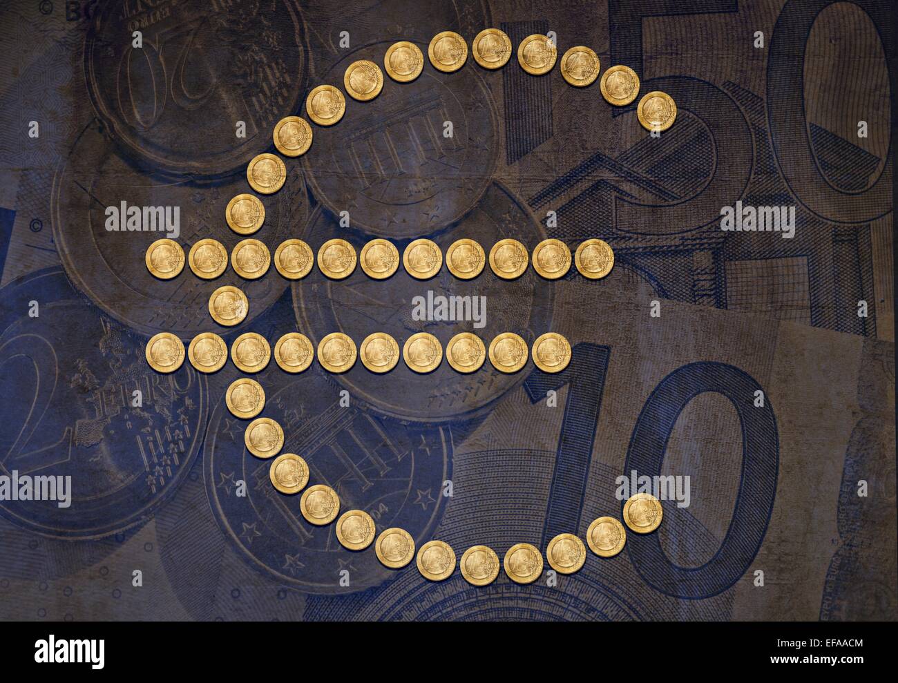 Group of one Euro coins, formed as Euro symbol on faded Euro money ...