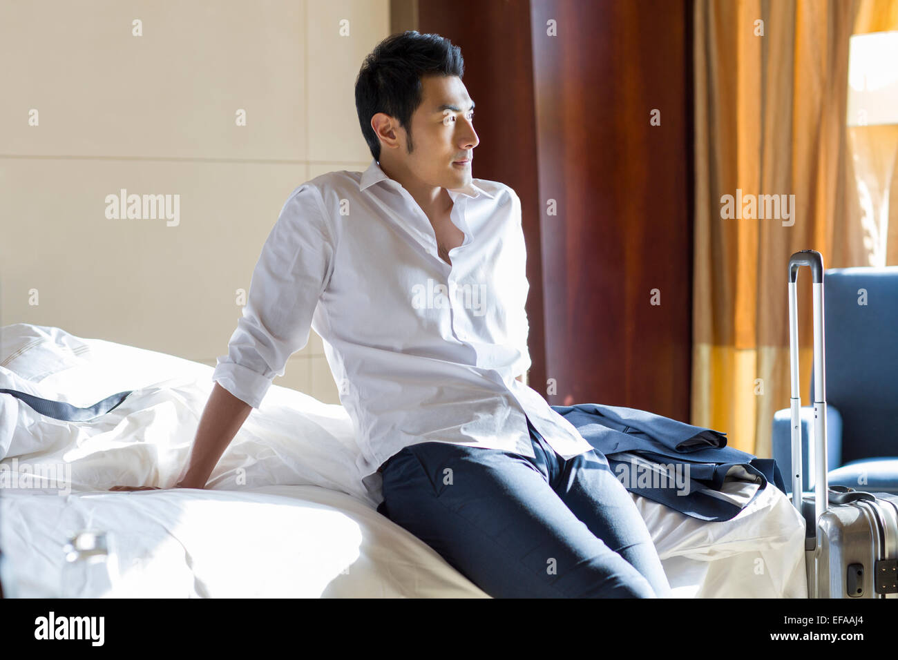 Young businessman resting in hotel room Stock Photo - Alamy