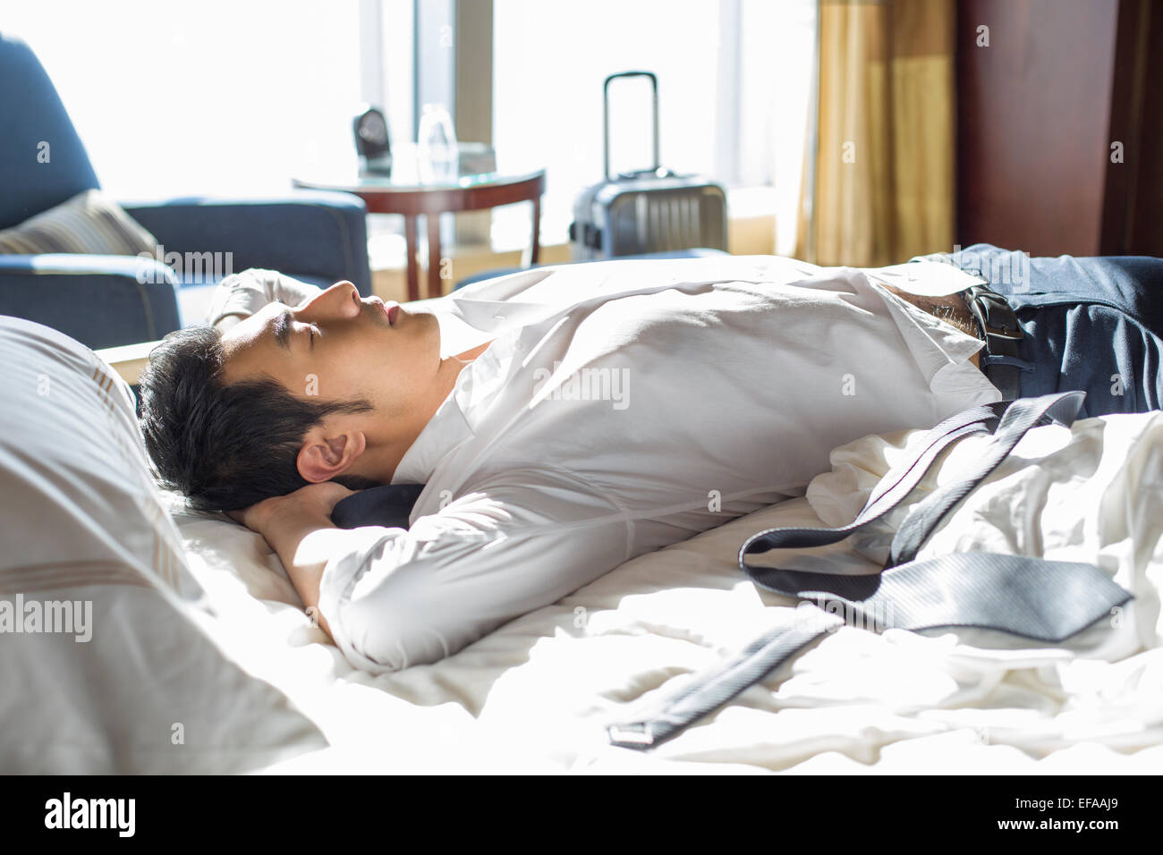 Young businessman resting in hotel room Stock Photo - Alamy