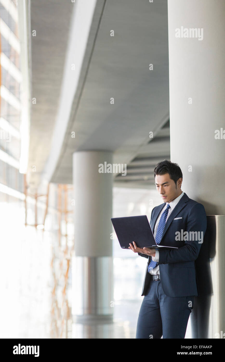 Young businessman using laptop Stock Photo - Alamy
