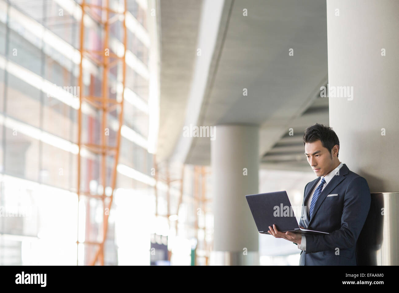 Young businessman using laptop Stock Photo - Alamy