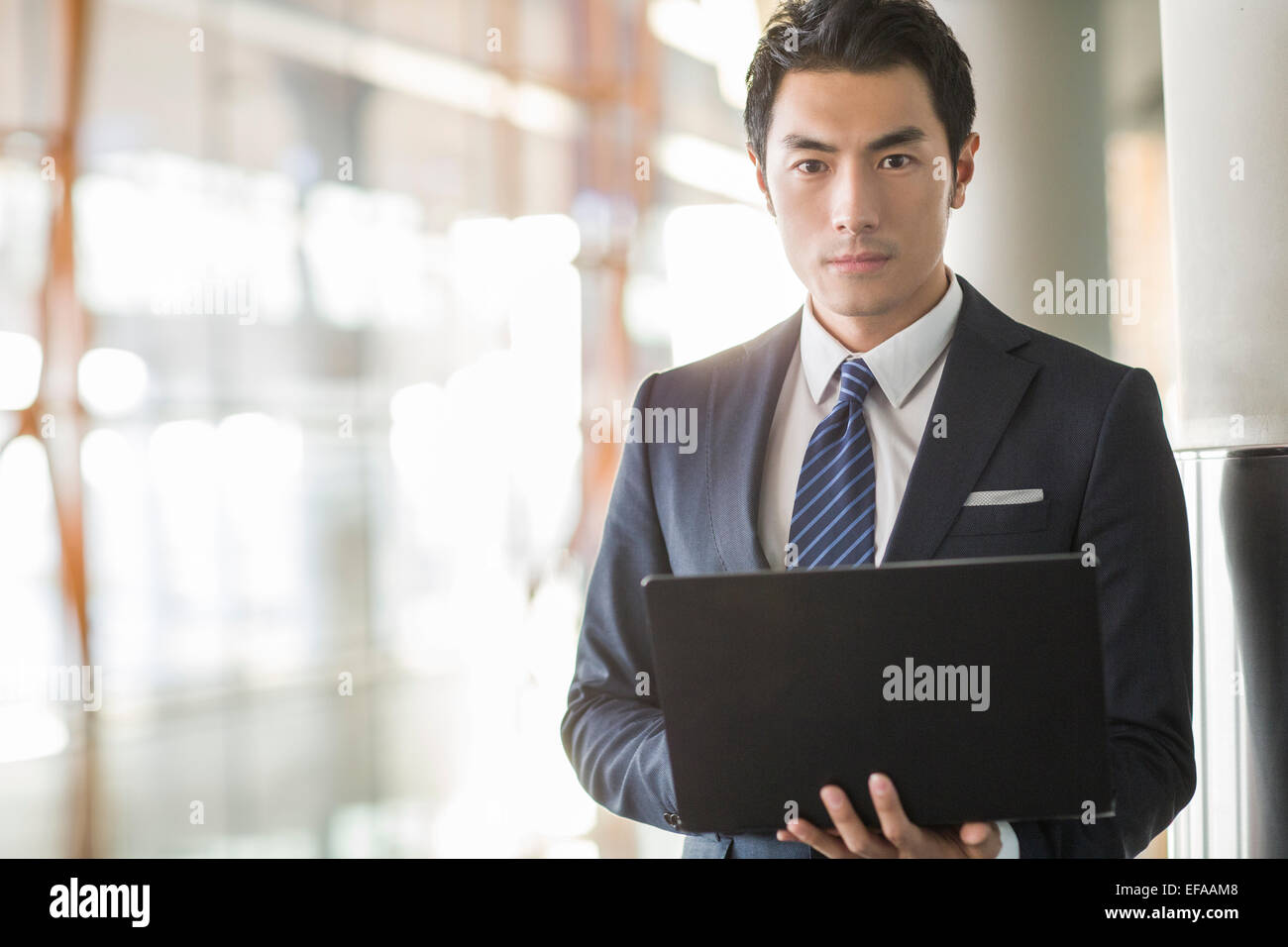 Young businessman using laptop Stock Photo - Alamy