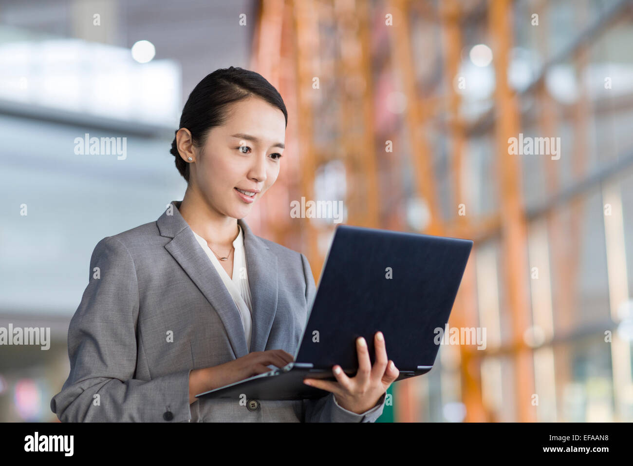 Young businesswoman using laptop Stock Photo - Alamy