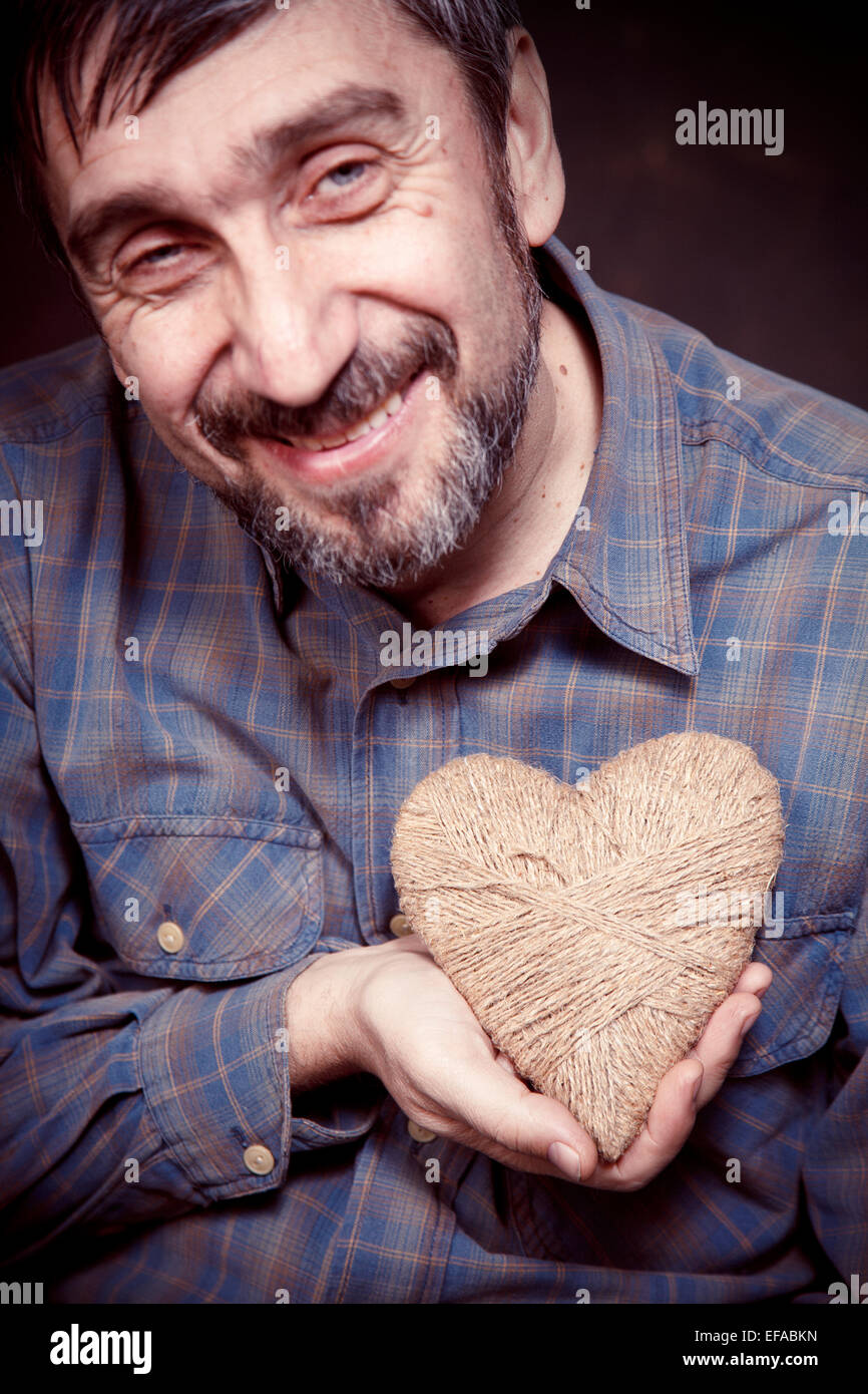 Man holding heart in his hands Stock Photo - Alamy