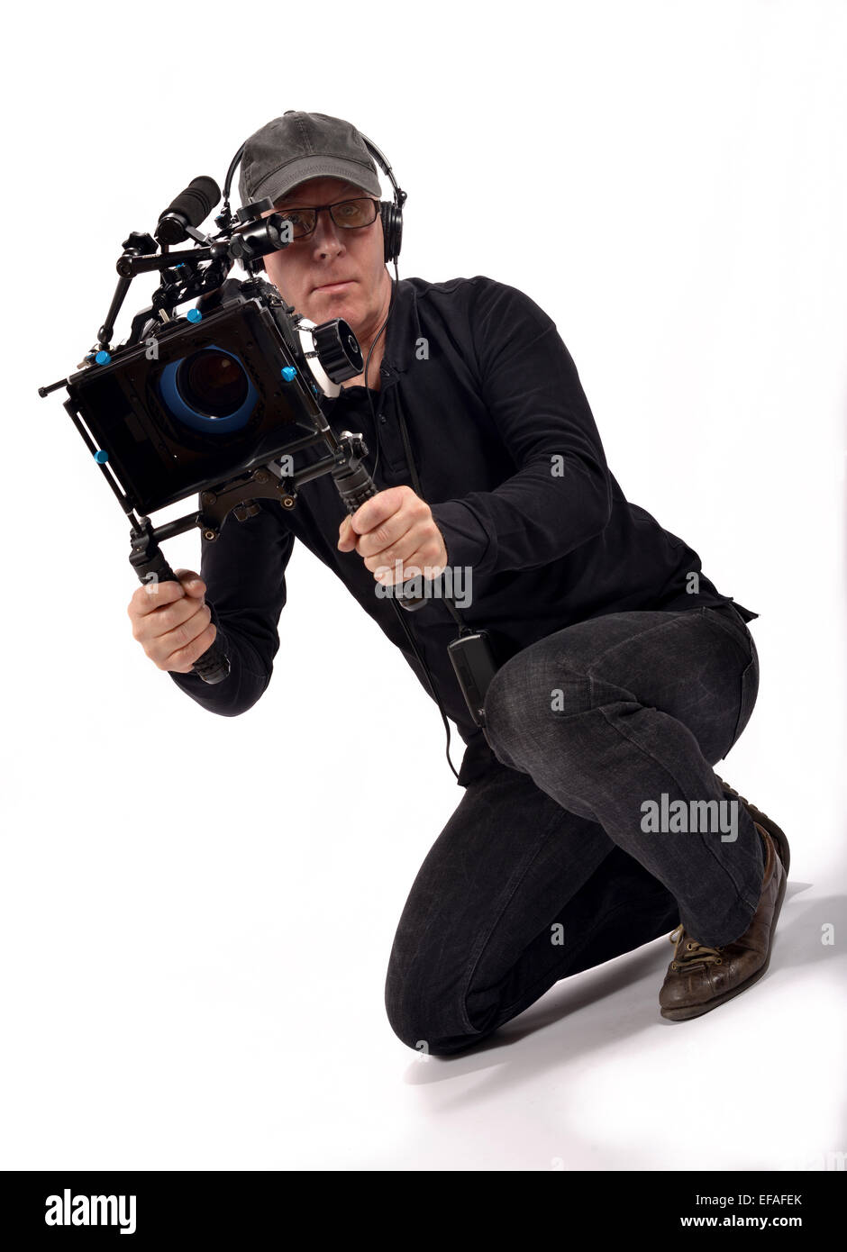 Man with camera on his shoulder to knees Stock Photo - Alamy