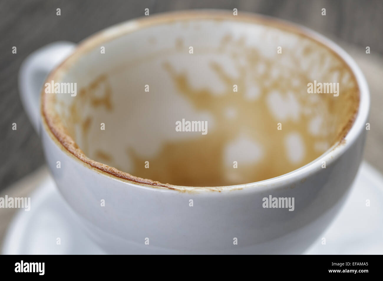 empty coffee cup on oak wood table Stock Photo - Alamy
