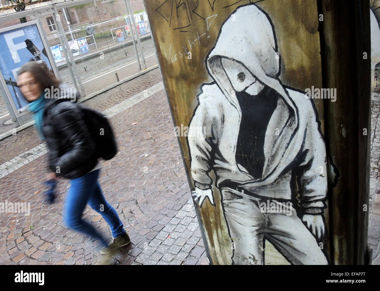 Painted cowl man "lurks" in a problem area in Freiburg (Germany), on ...