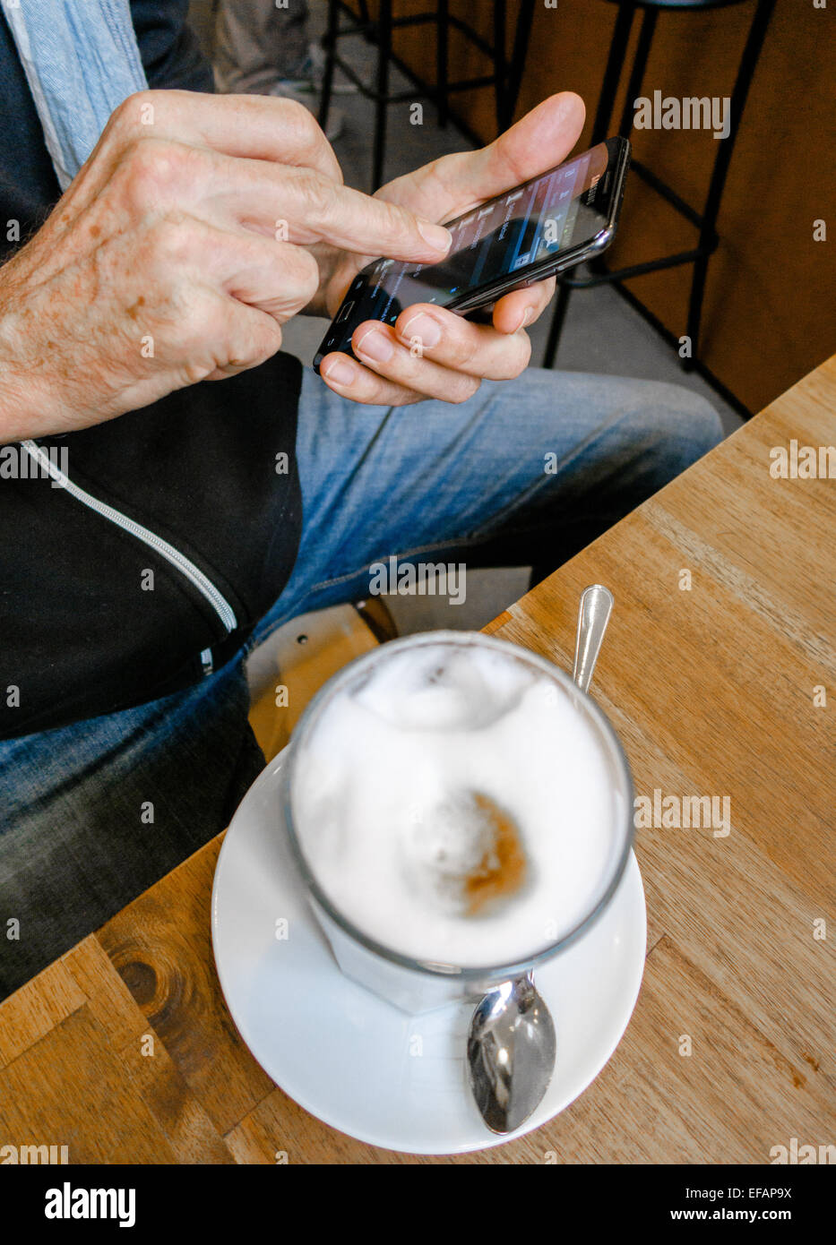 A man uses his cellphone, photo: January 13, 2015 Stock Photo - Alamy