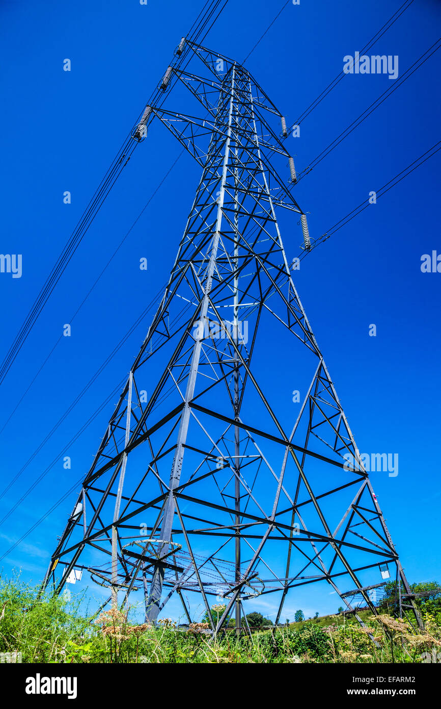 An electricity pylon against a cloudless blue sky Stock Photo - Alamy