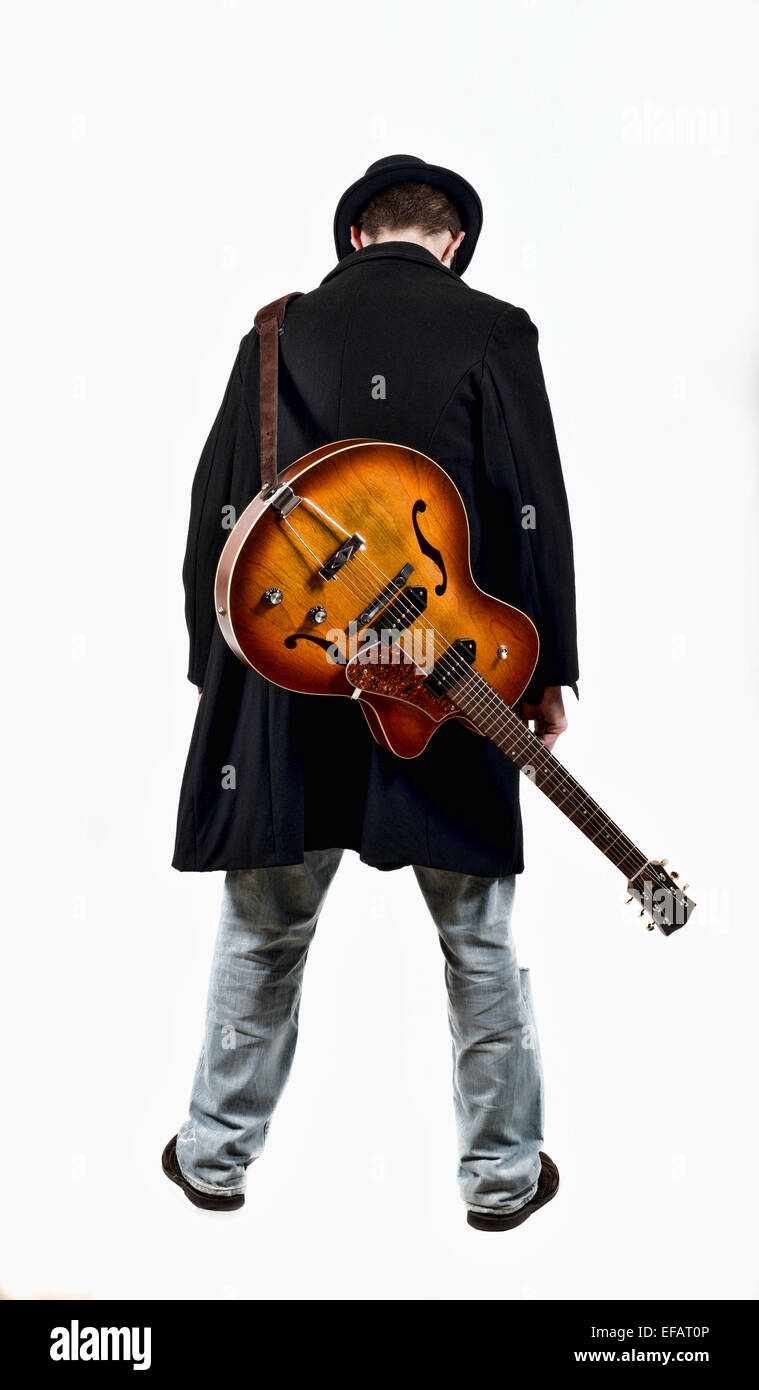 a guitarist with his guitar in the back isolated on white background ...