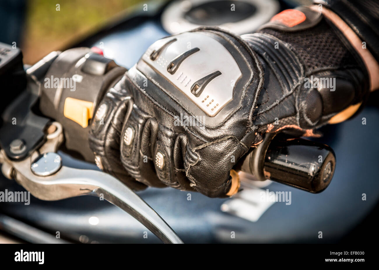 Human hand in a Motorcycle Racing Gloves holds a motorcycle throttle ...