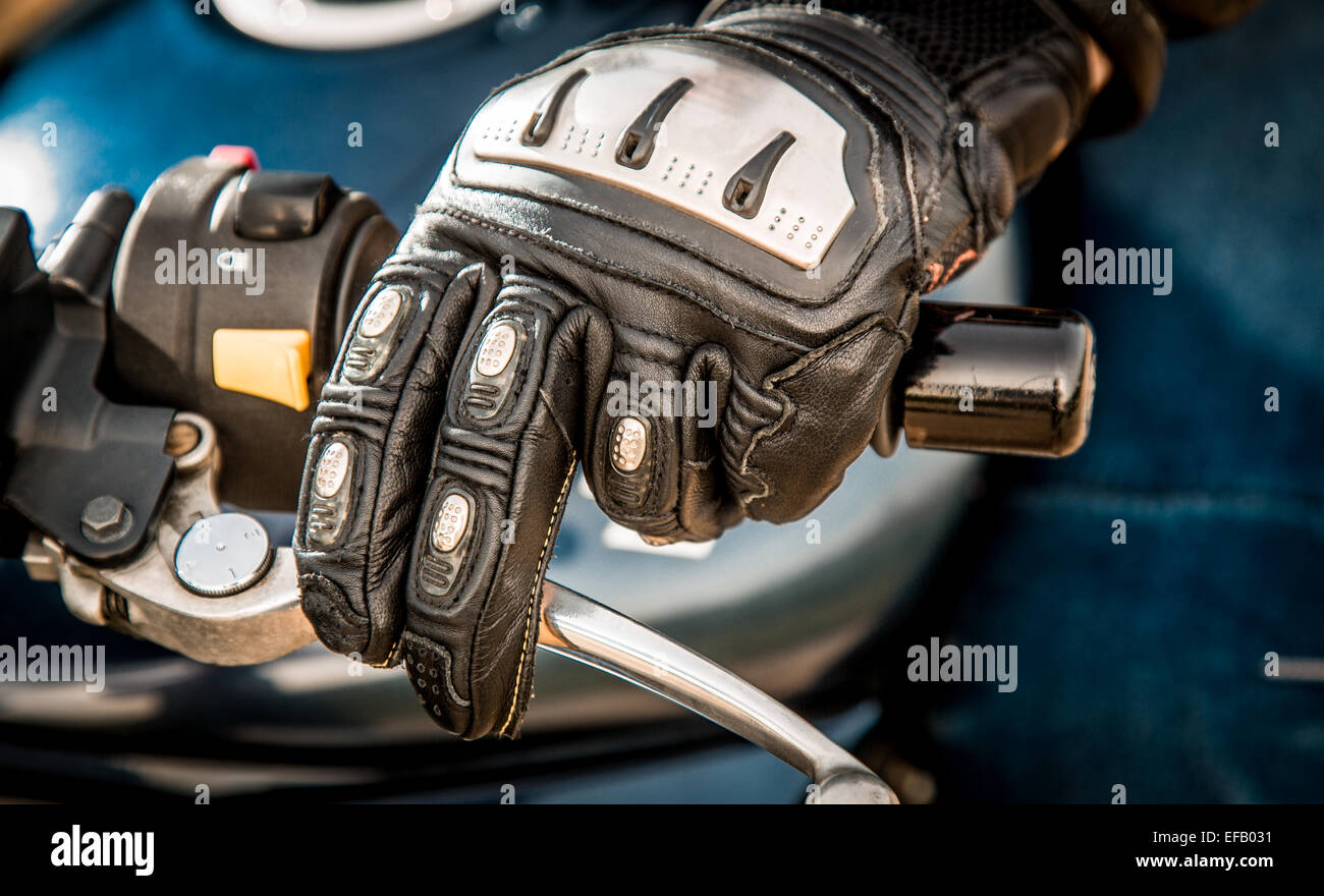 Human hand in a Motorcycle Racing Gloves holds a motorcycle throttle ...