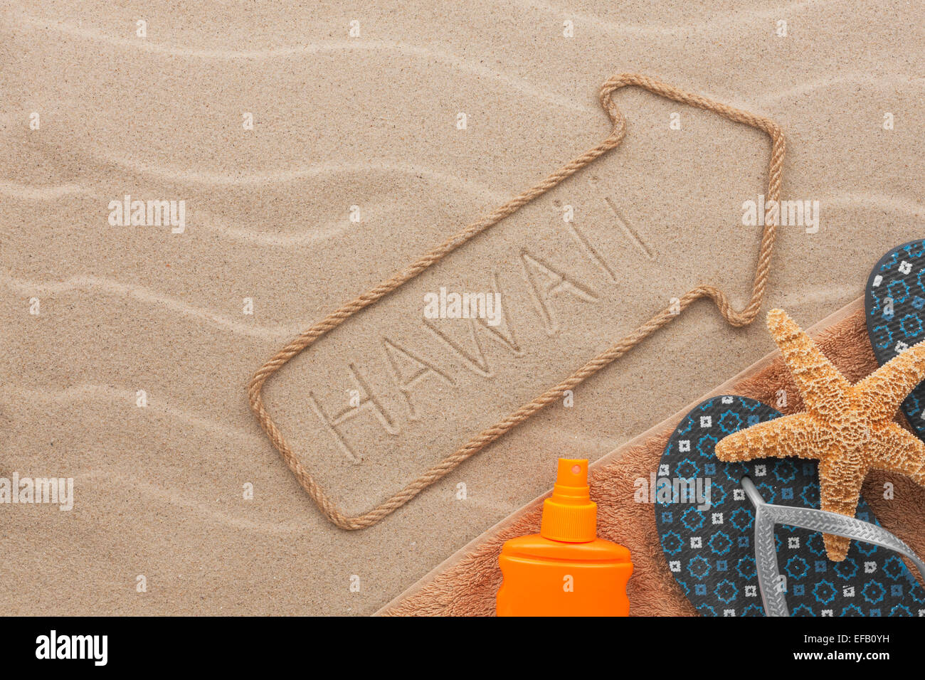 Hawaii pointer and beach accessories lying on the sand, as background ...