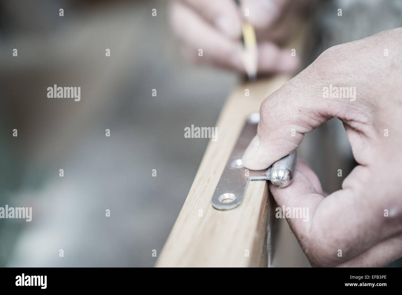 Closeup of carpenter hand with pencil working on door hinge Stock Photo ...
