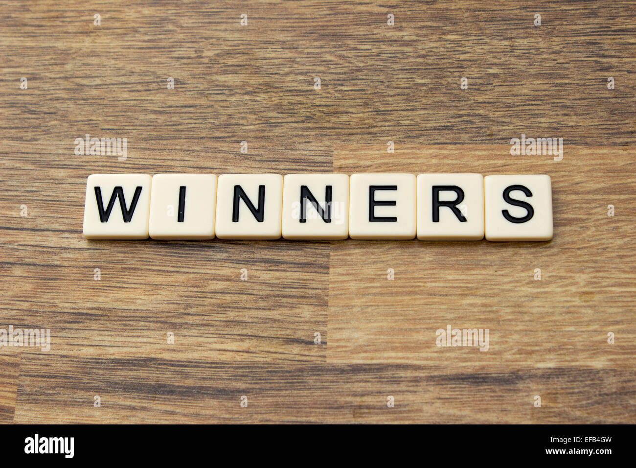 The word winners written in tiles on a wooden surface Stock Photo - Alamy