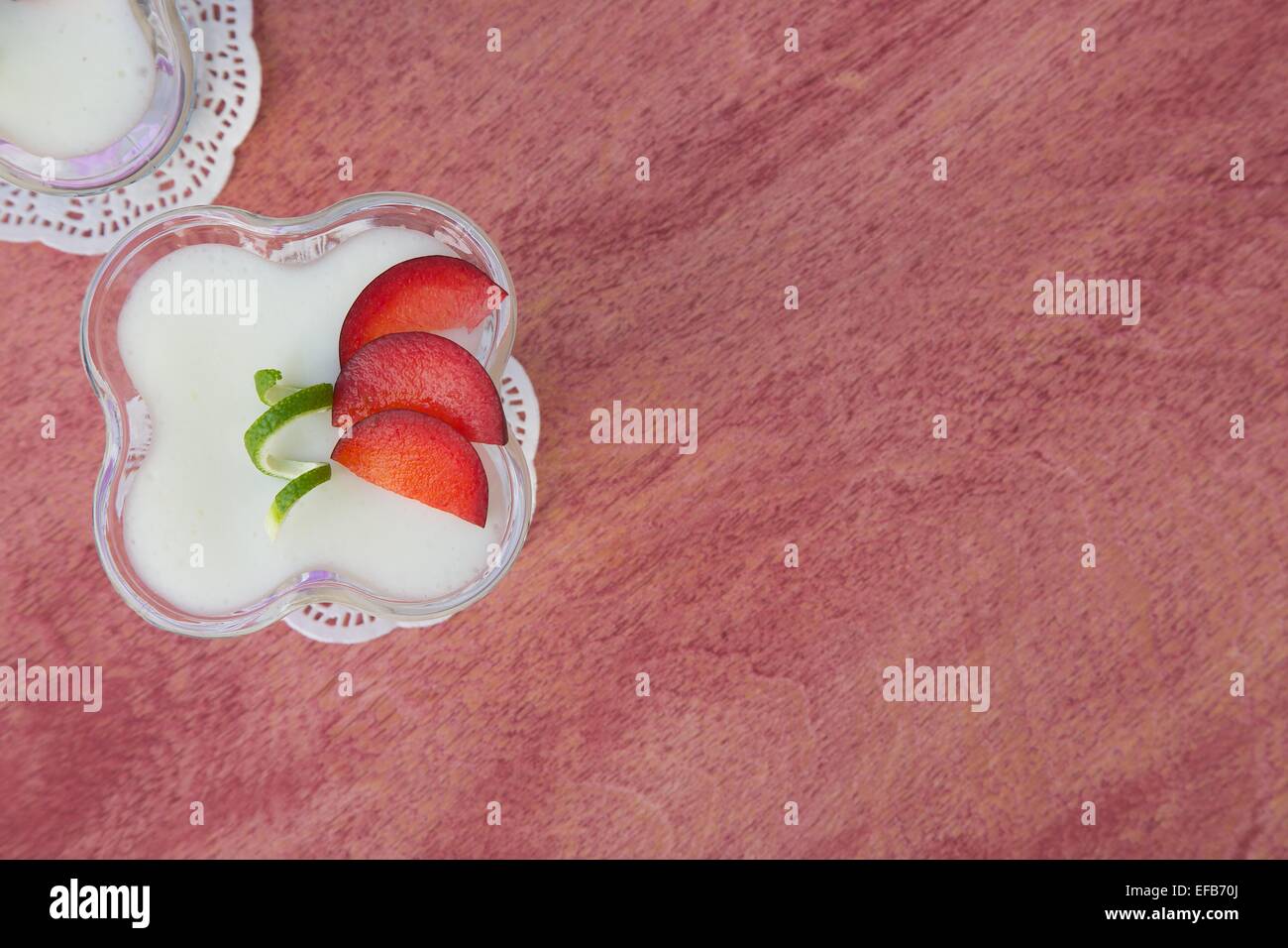 Milk desert - sweet ricotta with violet plums Stock Photo - Alamy