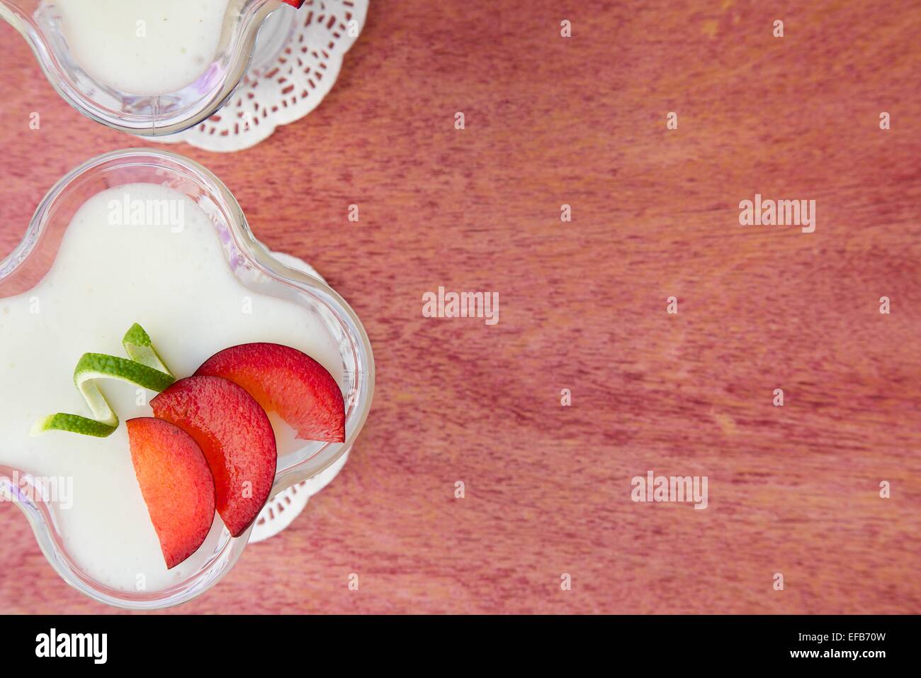 Milk desert - sweet ricotta with violet plums Stock Photo - Alamy