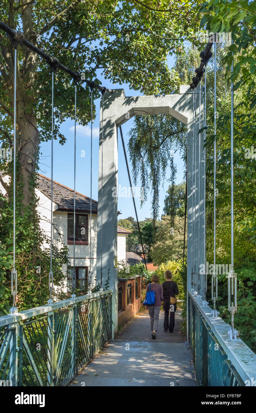 Two walkers on suspension bridge over River Exe at Exeter Quays Devon ...