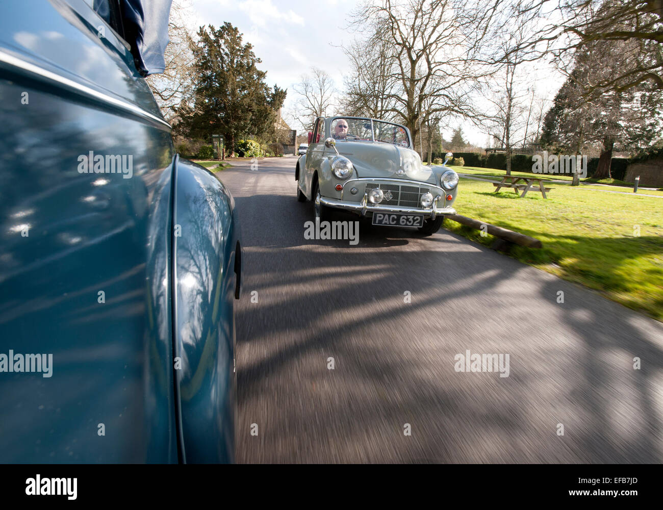 Pair of Morris Minor convertible British classic cars driving Stock ...