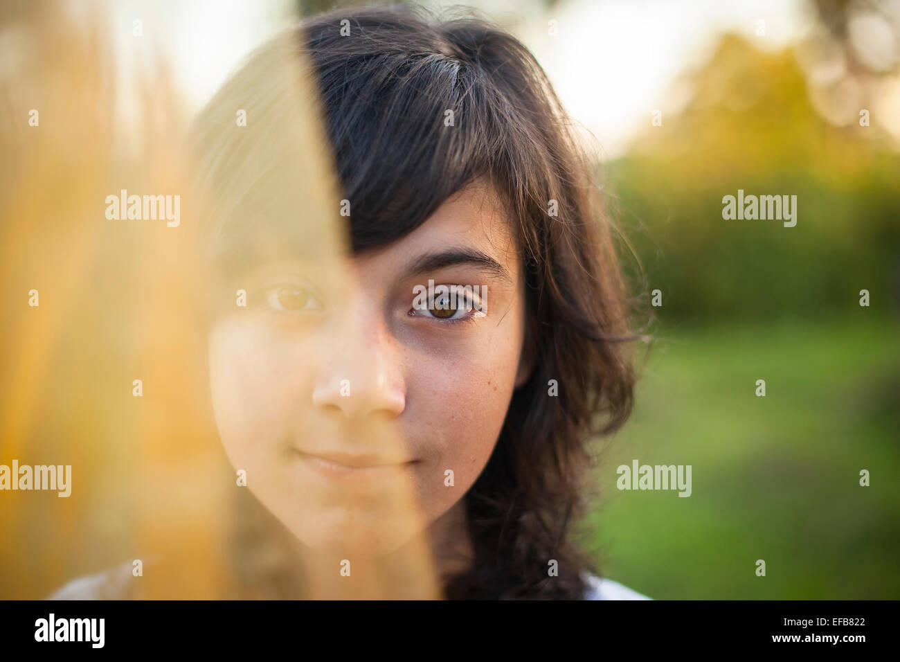 Young cute girl portrait half face hidden behind a veil Stock Photo - Alamy