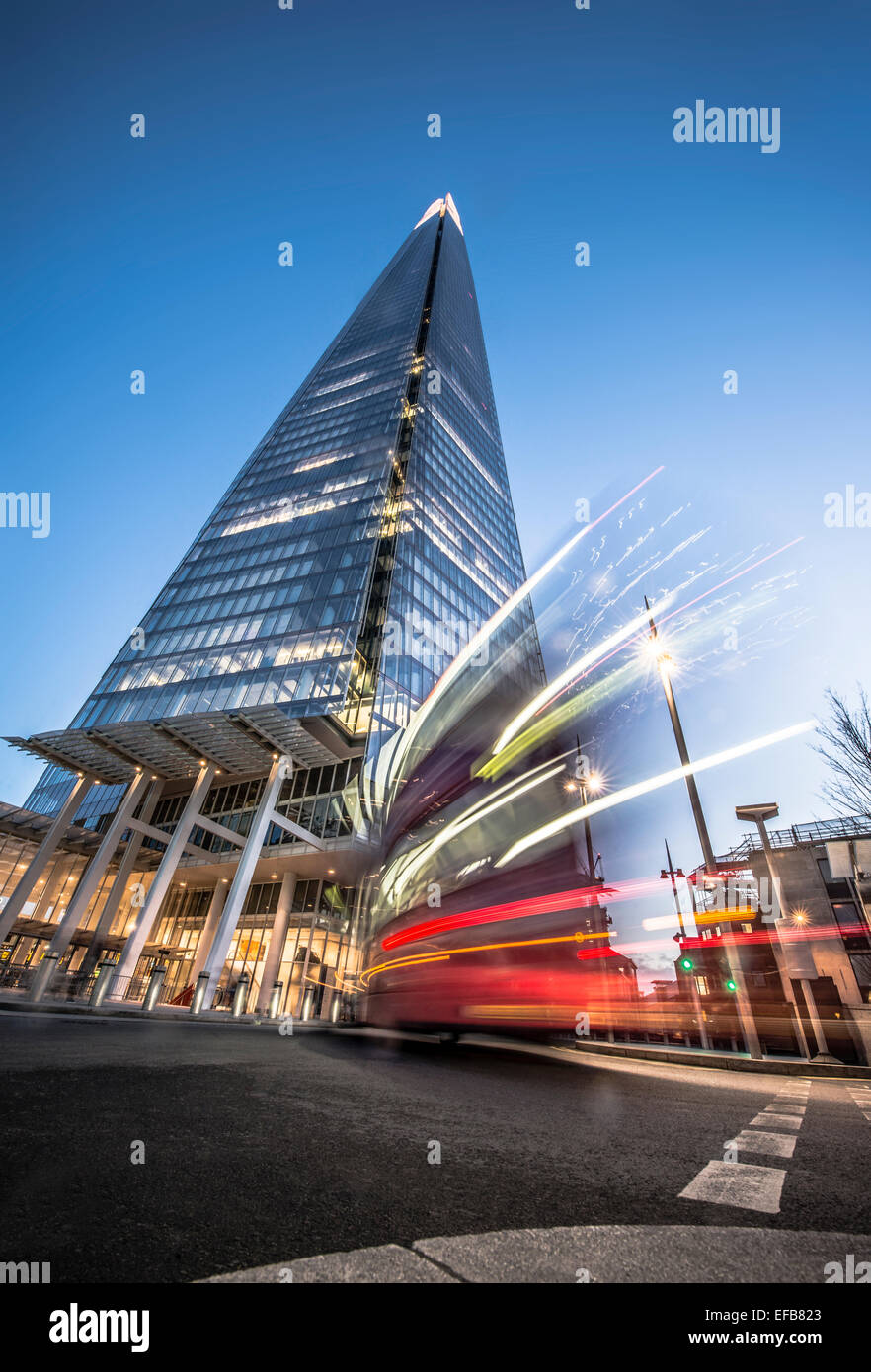 The Shard at dusk with bus moving past Stock Photo - Alamy