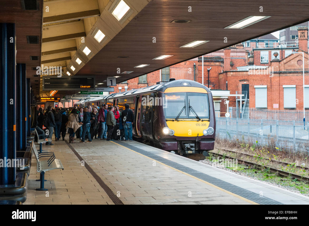 Passengers standing queue railway platform hi-res stock photography and ...