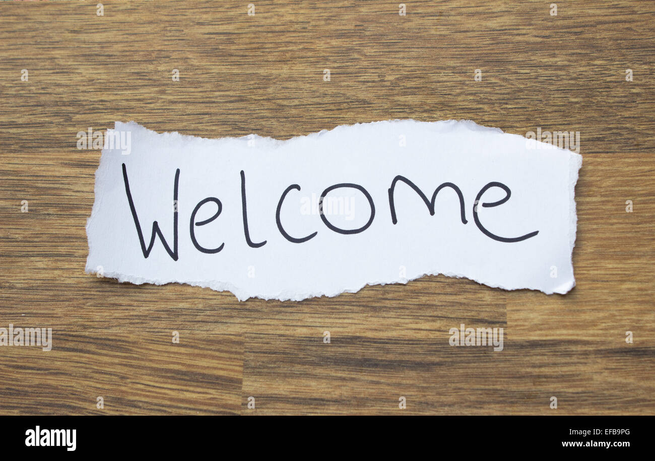 Welcome written on torn paper, placed on wooden background Stock Photo ...