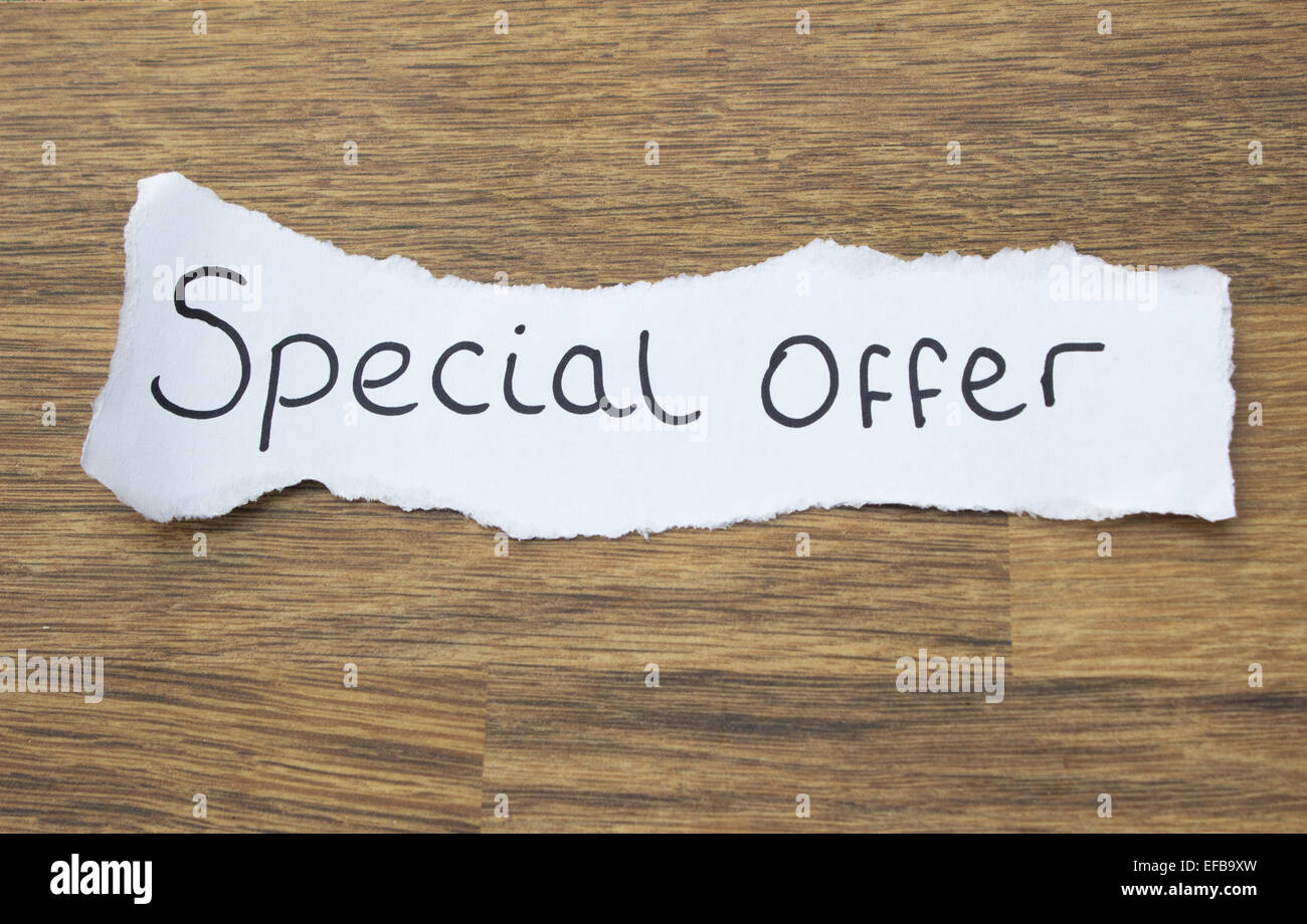 Special Offer written on torn paper, placed on wooden background Stock ...