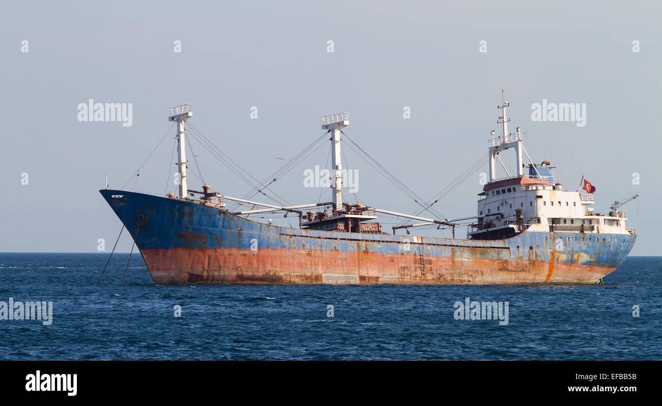 A Rusty Cargo Ship is anchored in Sea Stock Photo - Alamy