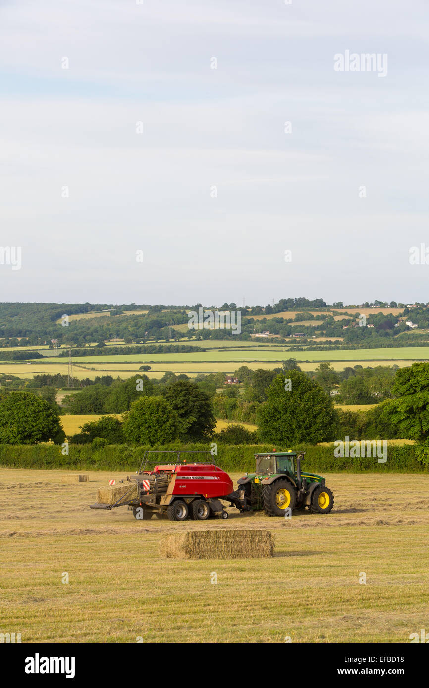 Tractor and hay baling baling hay in field, Oxfordshire, England Stock ...