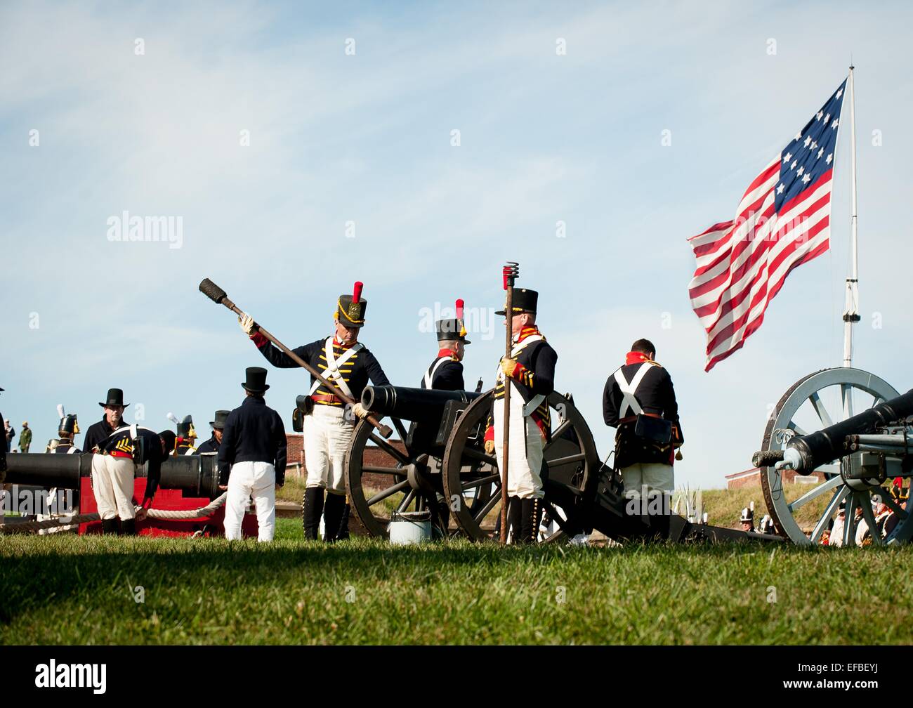 Re-enactors wearing period costumes prepare to fire a historic canon in ...