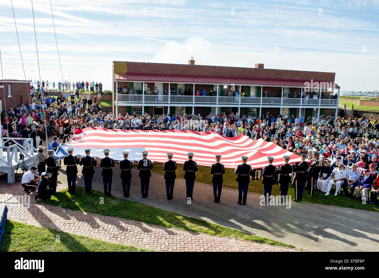 Re-enactors wearing period costumes unveil a giant American flag in ...