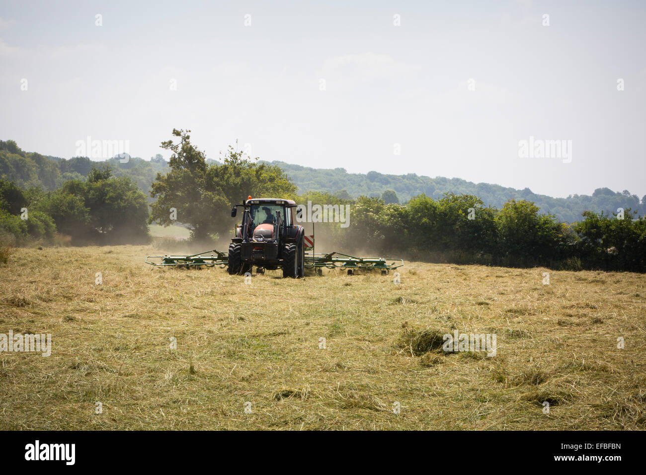 Tedder turning grass hi-res stock photography and images - Alamy