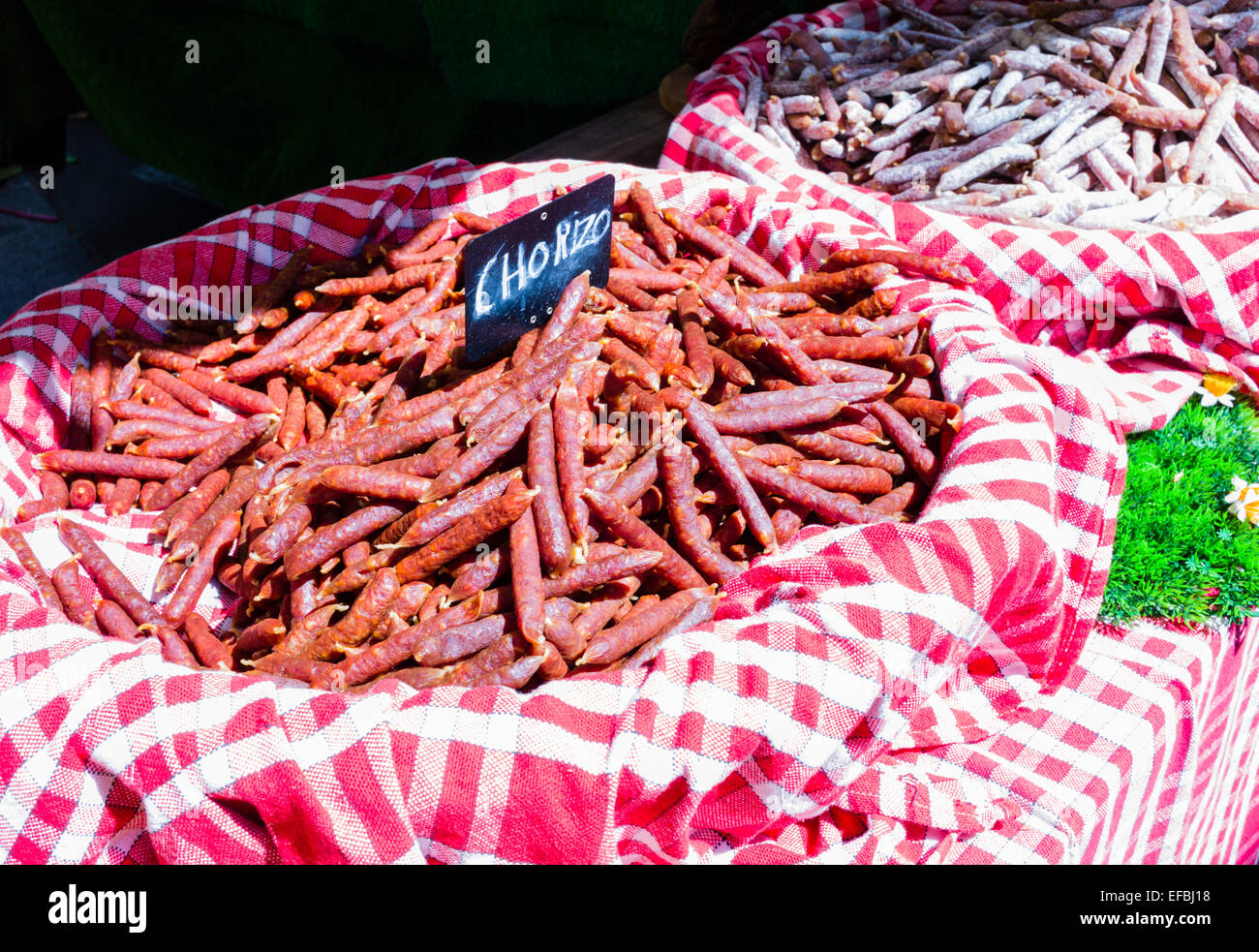 Chorizo sausages on red and white cloth in French market in Paris ...