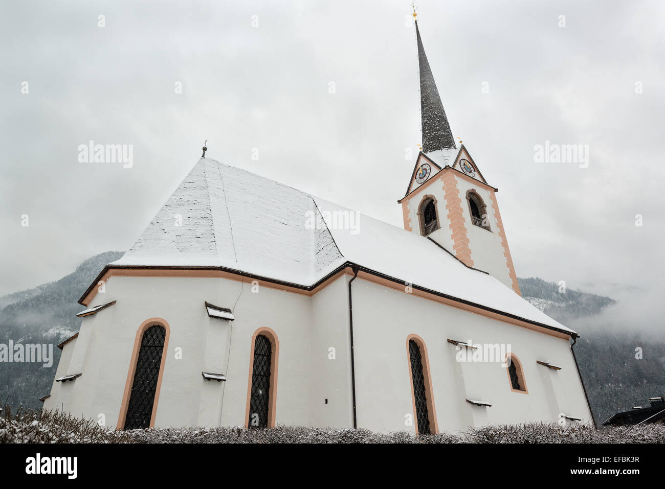 Beautiful church with mountains Stock Photo - Alamy