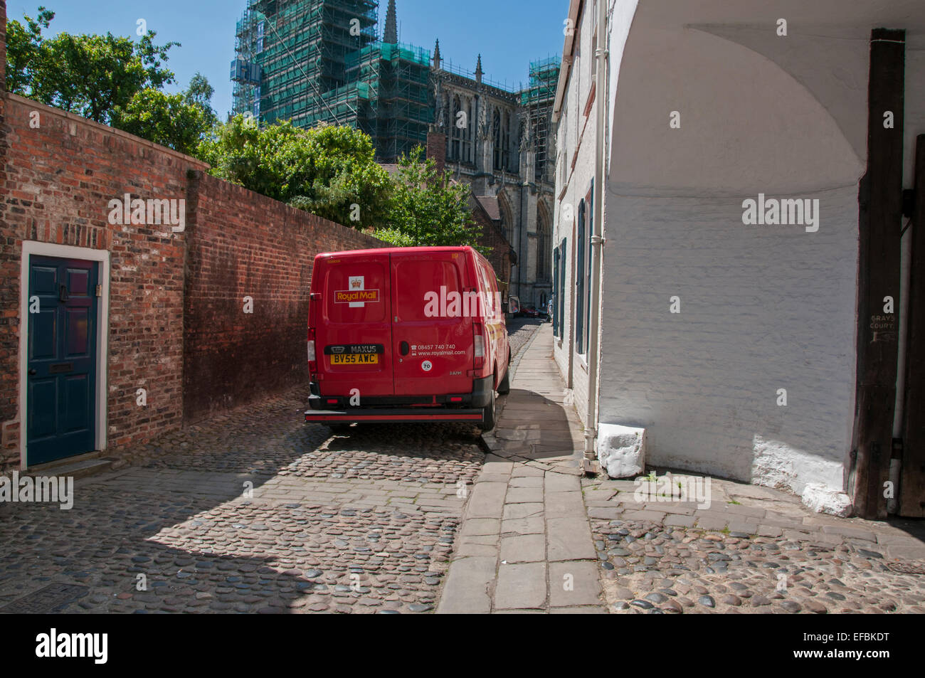 Bright red Post Office van parked on historic, narrow and cobbled ...