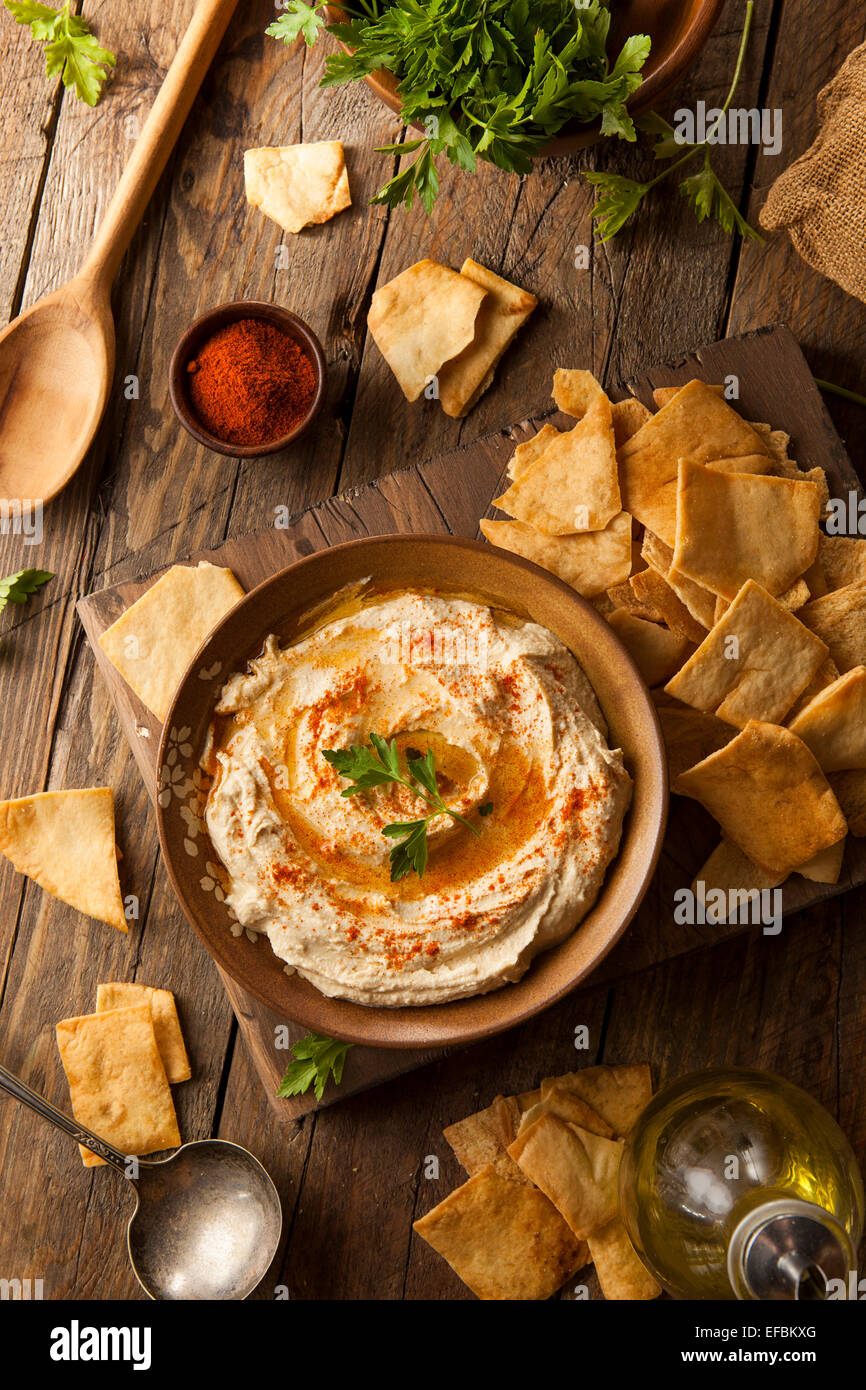 Healthy Homemade Creamy Hummus with Olive Oil and Pita Chips Stock ...